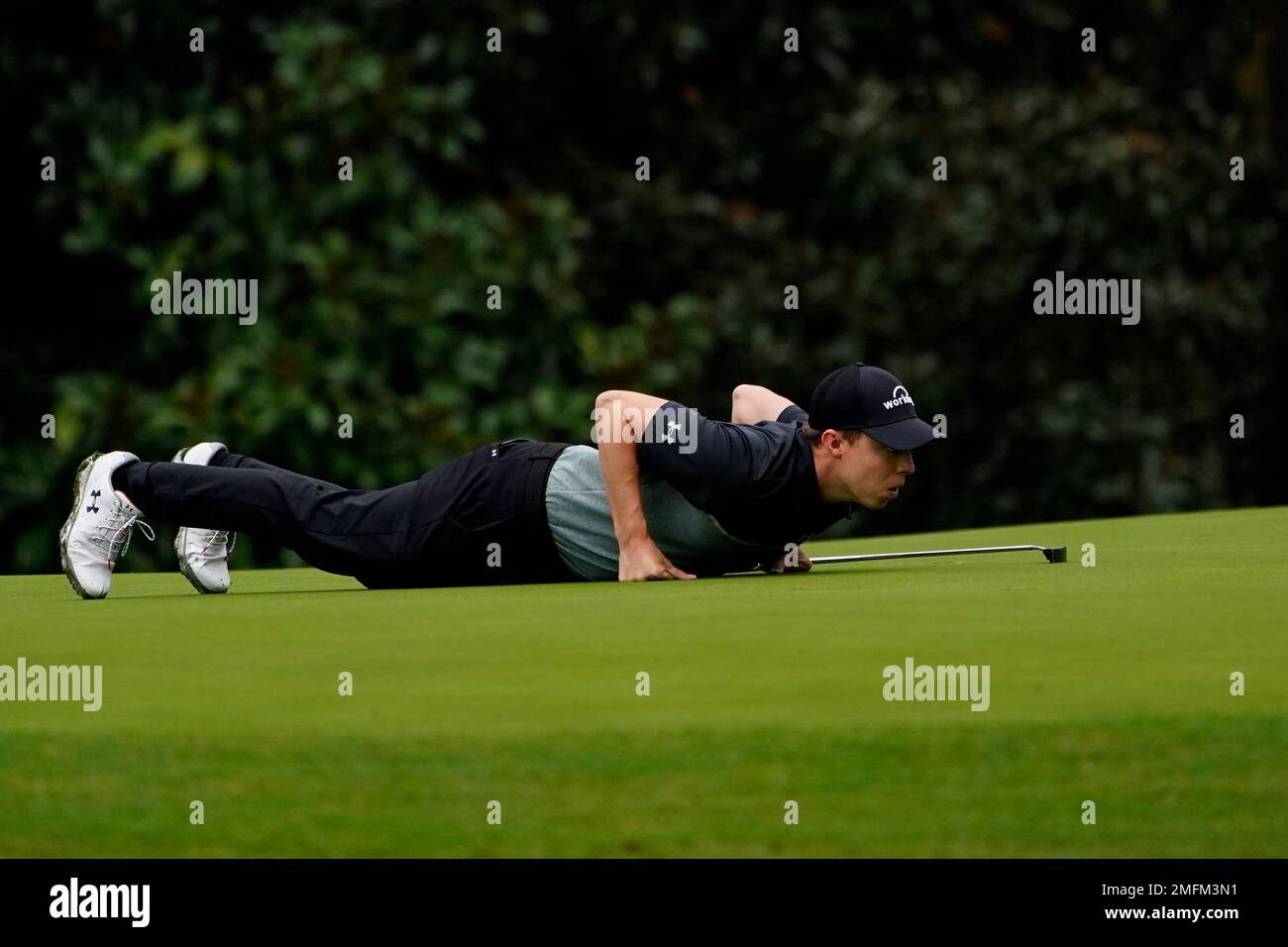 Matthew Fitzpatrick, of England, lines up his putt on the 14th green ...