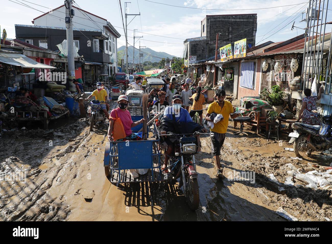 Residents return to their homes in the typhoon-damaged Kasiglahan ...