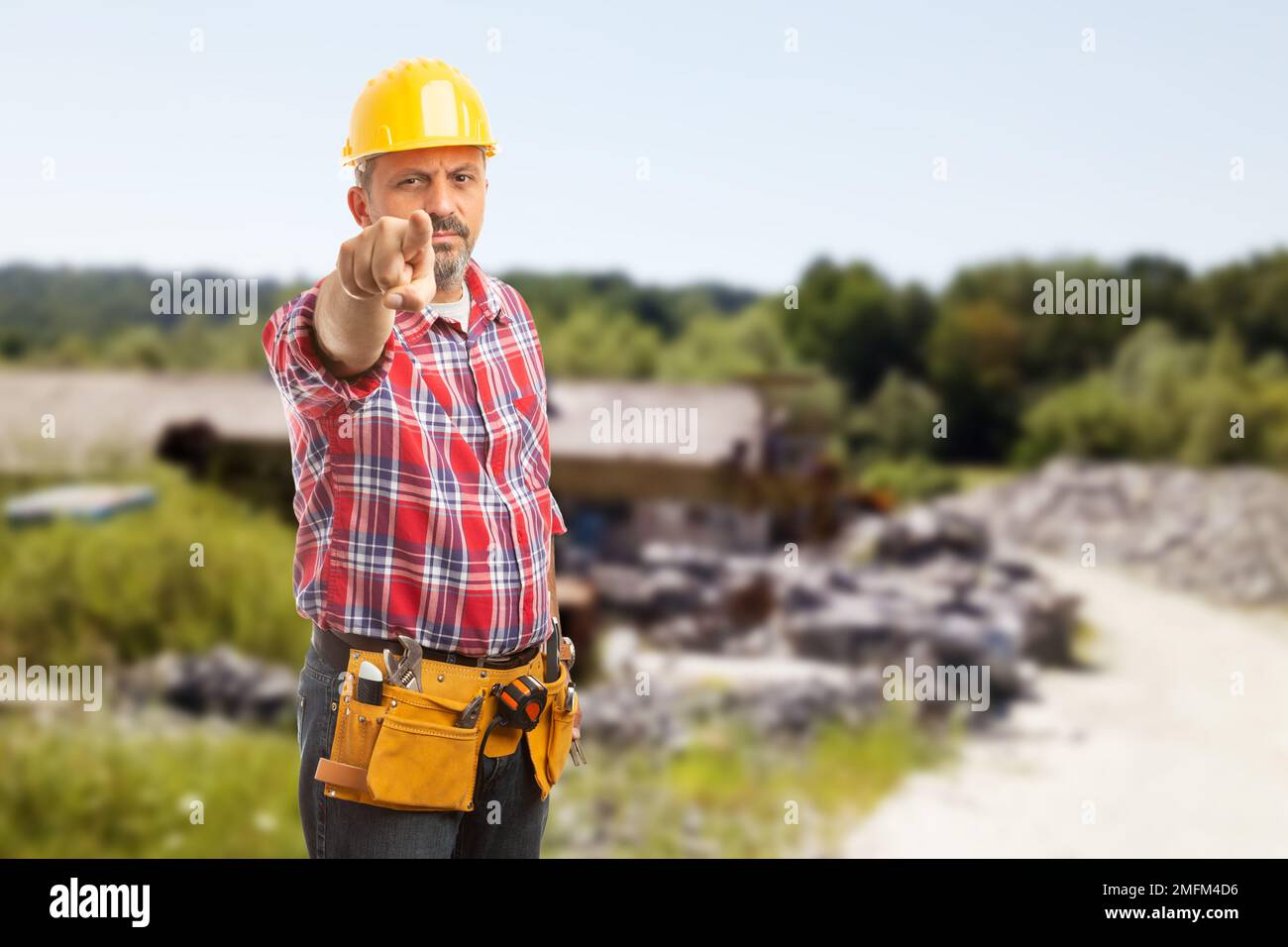 Frowning man doing pointing gesture as authority concept and workplace ...