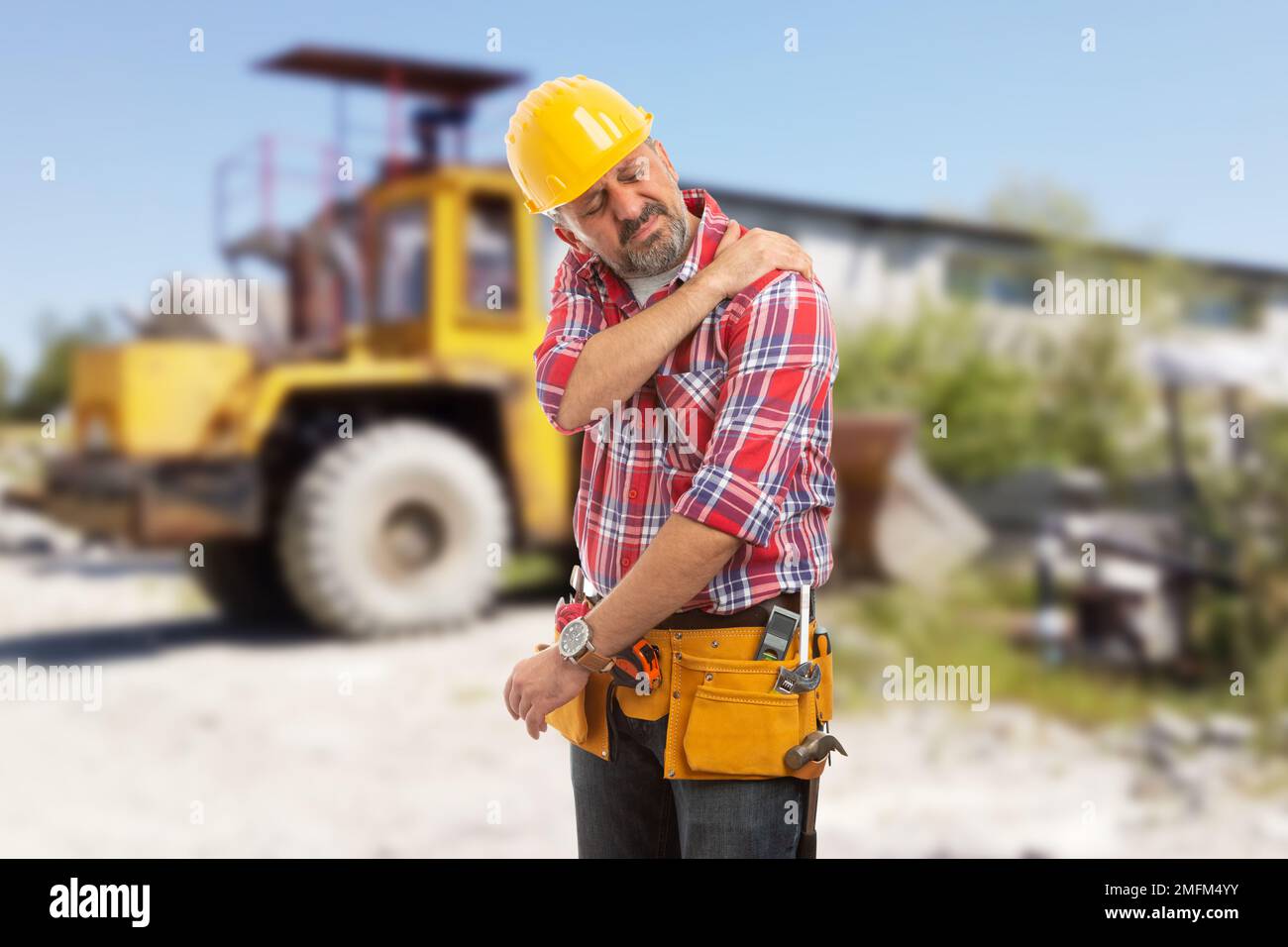 Worker stretching with hand on shoulder as hard-working concept Stock ...