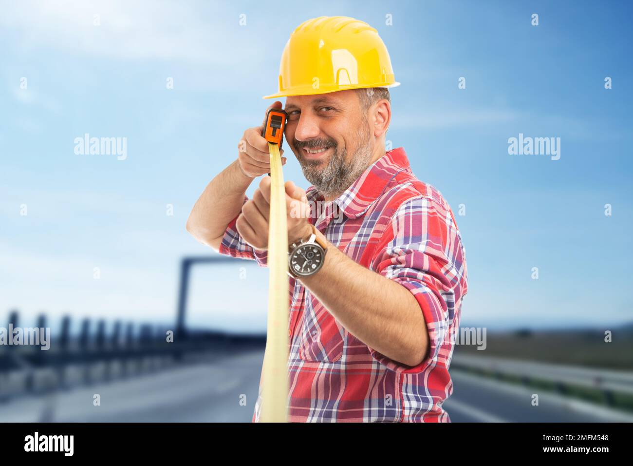 Close-up of male worker grabbing ruler with hands as measurement tool ...