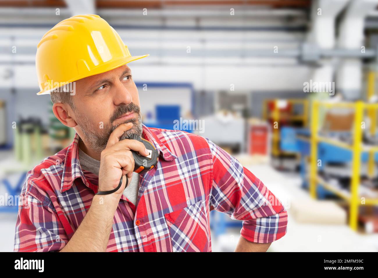 Male making thinking gesture with hand on chin and holding ruler as ...
