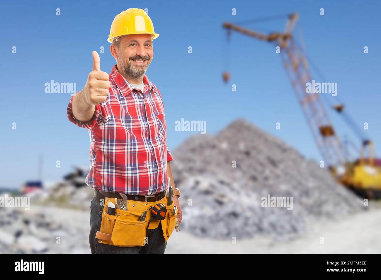 Adult man making thumbs-up gesture with hands on working environment ...