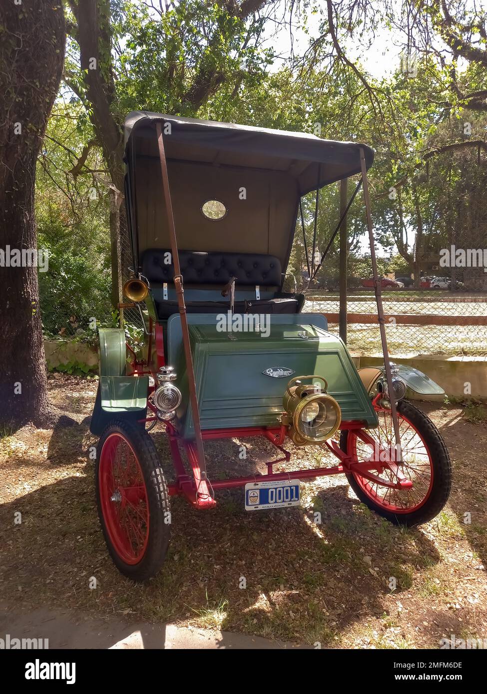 Antique green 1902 Rambler Model D Runabout roadster in a park. Nature ...