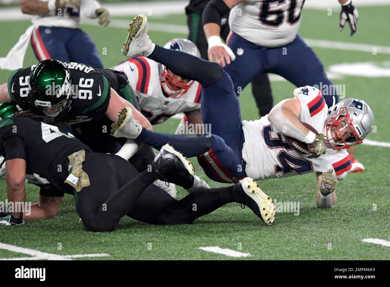 New England Patriots running back Rex Burkhead (34) is tackled by New ...