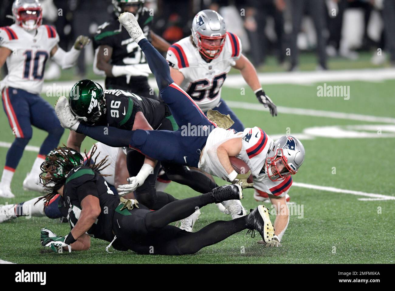 New England Patriots running back Rex Burkhead (34) is tackled by New ...