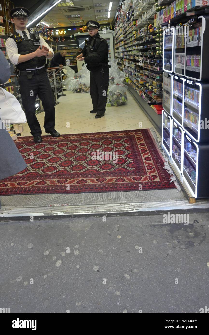 London, England, UK. Police officers confiscating items from a shop in ...