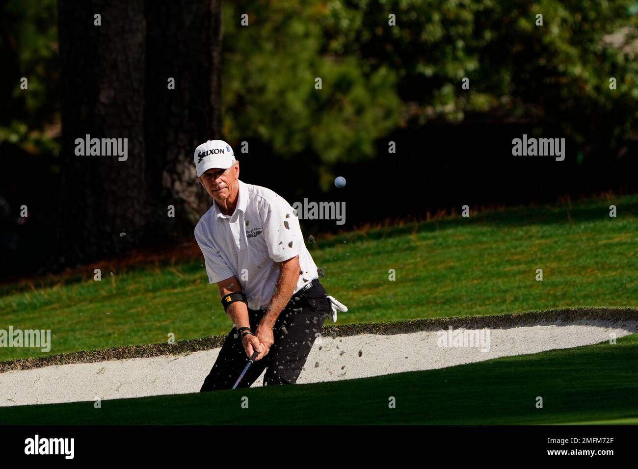 Larry Mize chips out of a bunker on the seventh hole during the first ...