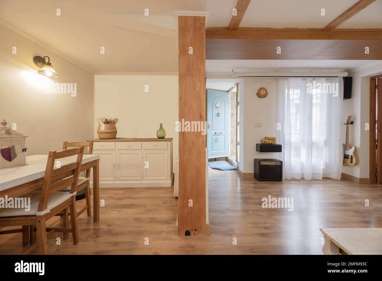 Two-room living room with wooden dining table and matching white wooden ...