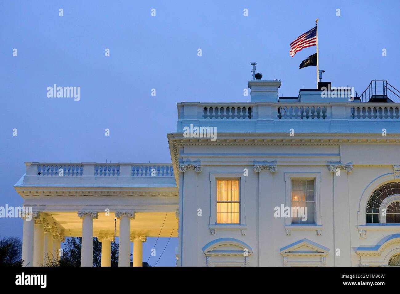Lights shine from inside the White House at dusk, Wednesday, Nov. 11 ...