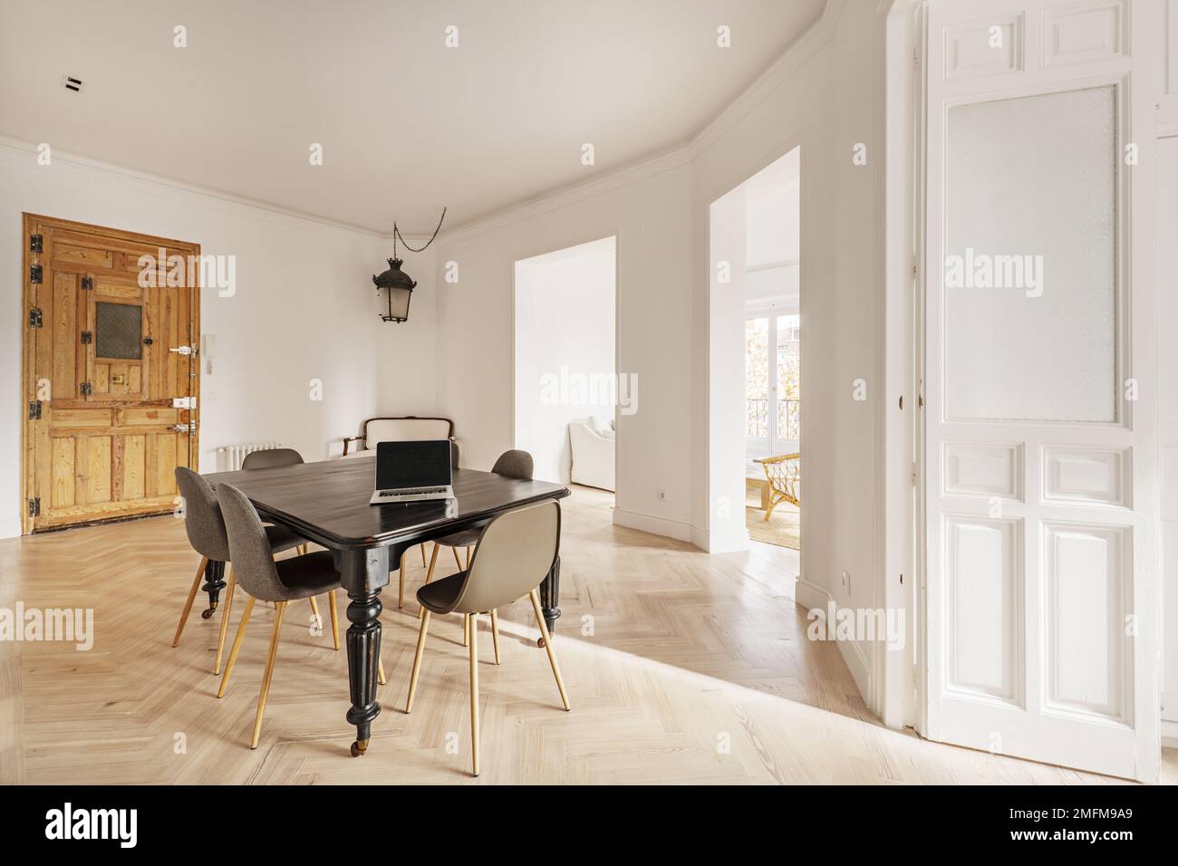 Hall of a house with a black wooden table and access to a multitude of ...