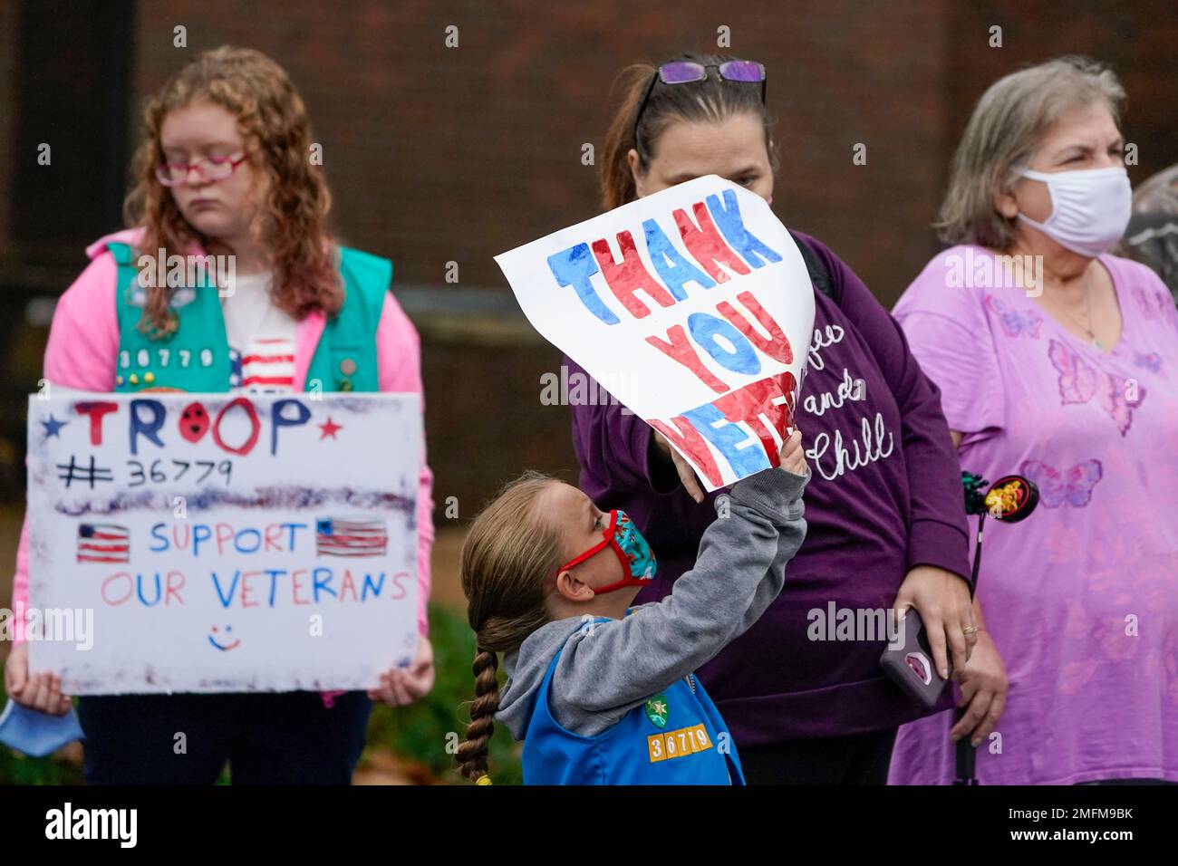 Six-year-old Sara Link holds up a sign thanking veterans as she stands ...