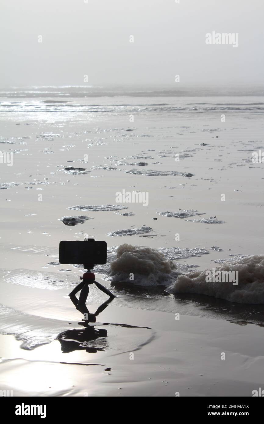 Cellphone camera and tripod set-up on beach. Concept for artist ...