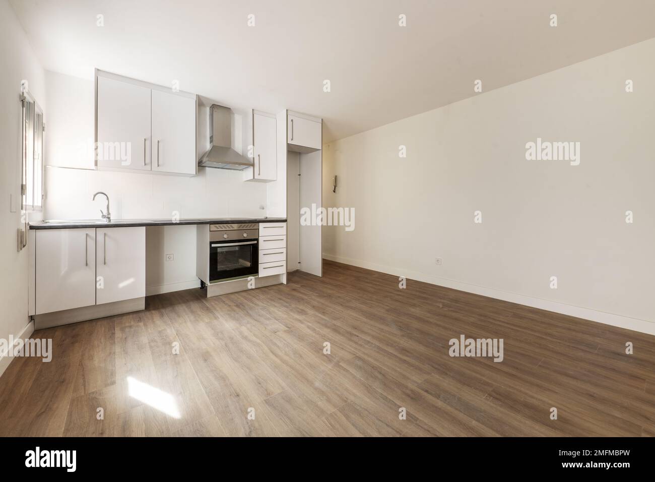 Kitchen open to newly installed empty living room that is missing some ...