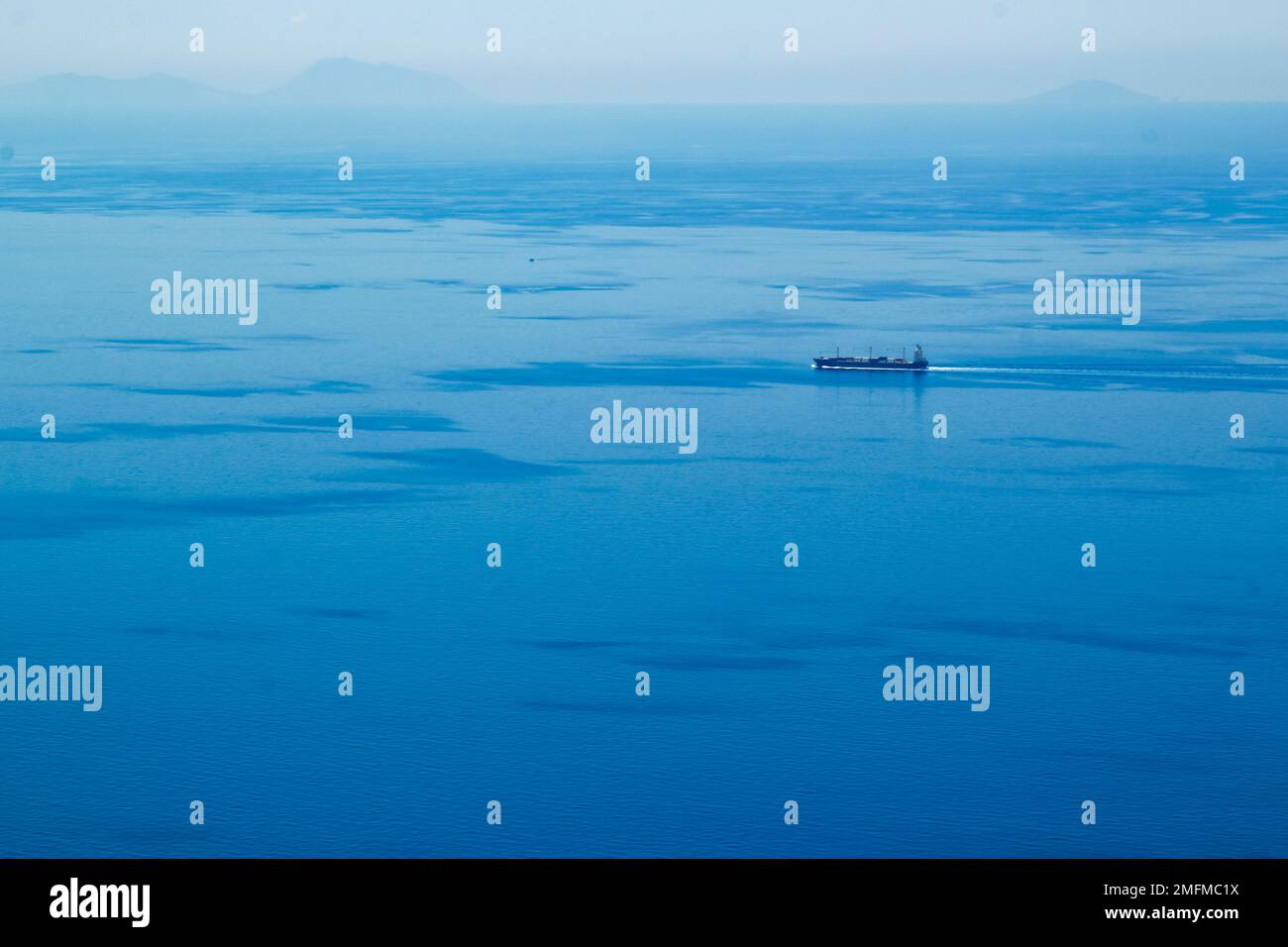 maritime coast of the Tyrrhenian Sea with merchant ship, travel ...