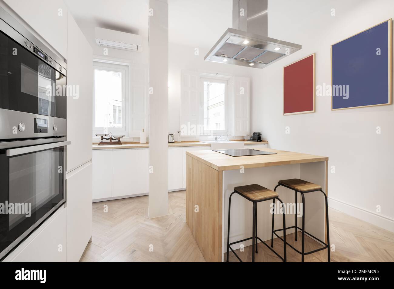 Contemporary design kitchen with white furniture without handles, an ...