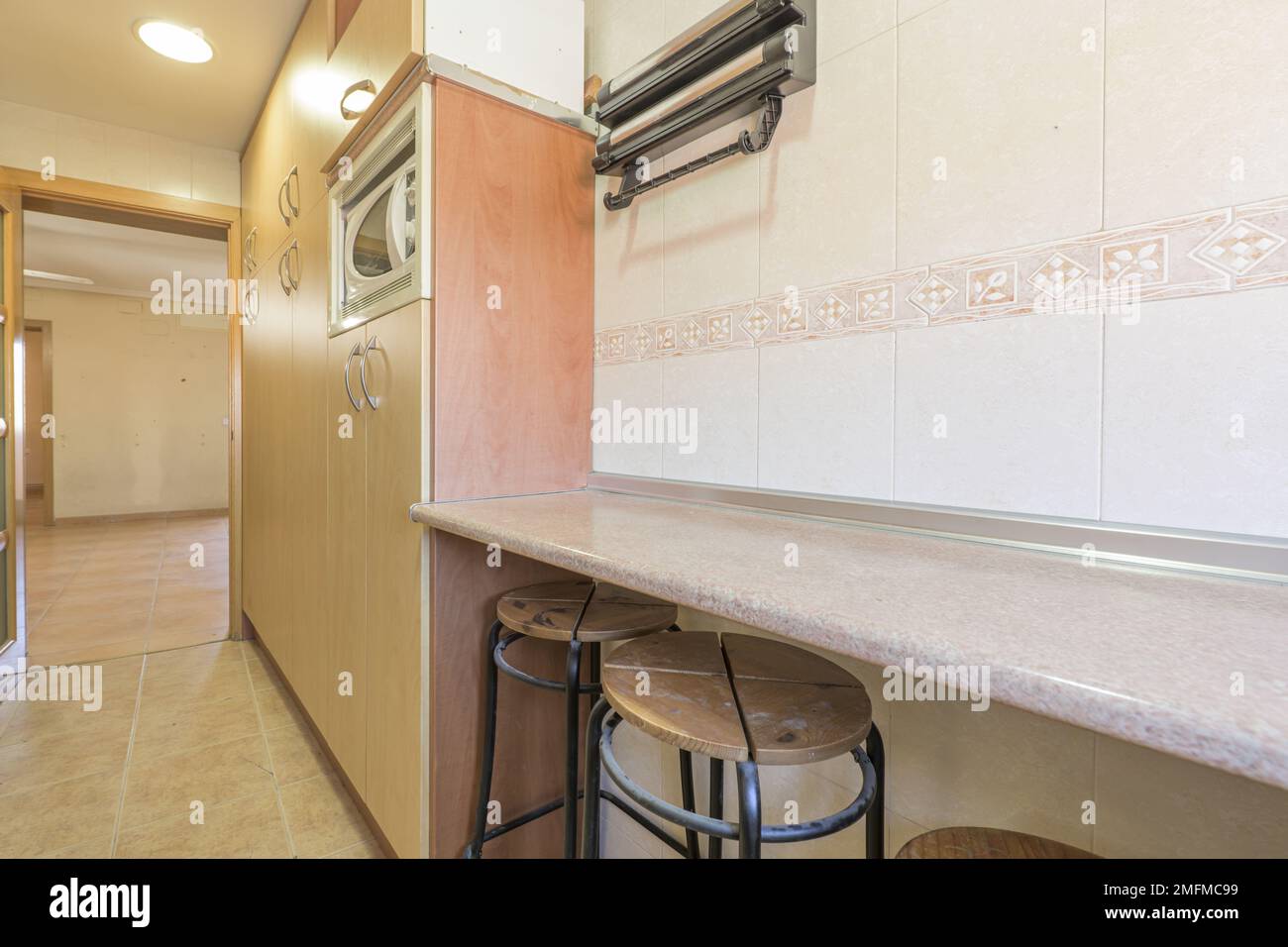 Contemporary kitchen with floor-to-ceiling cabinets in light beech wood ...