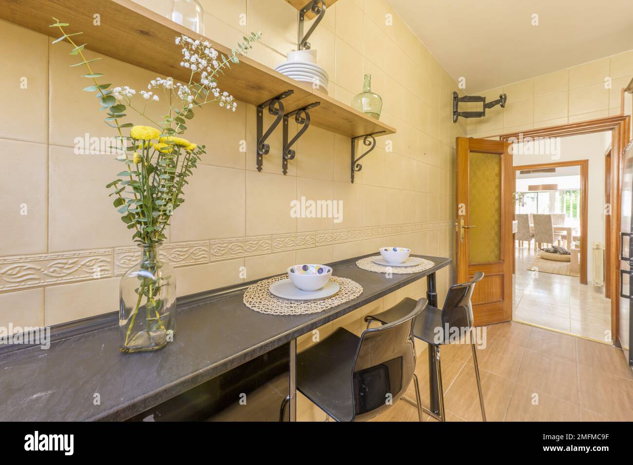 Contemporary kitchen with bar counter with metal and shiny resin stools ...