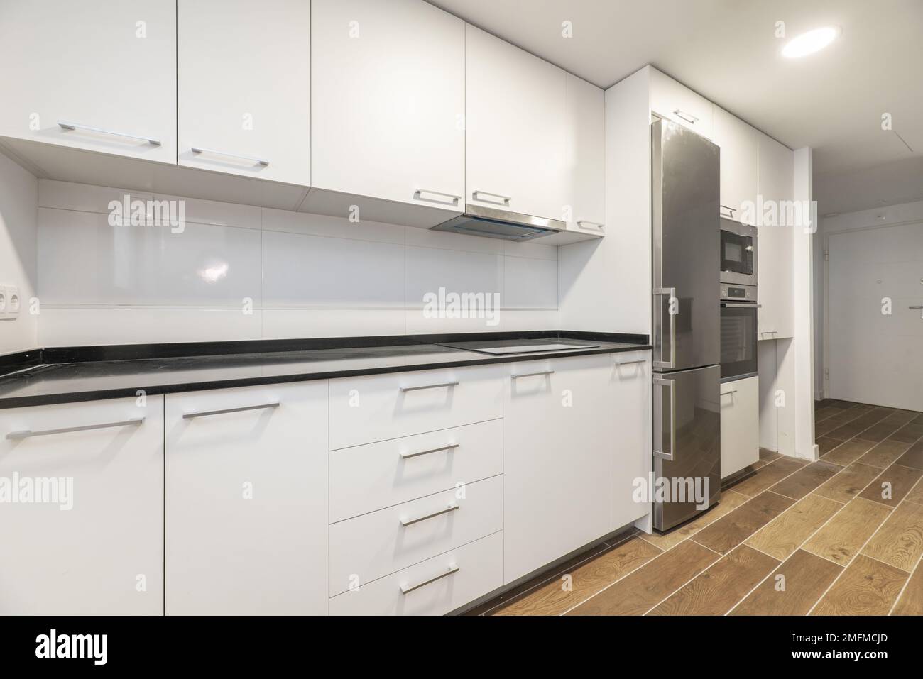 Newly installed white cabinet kitchen with integrated stainless steel ...