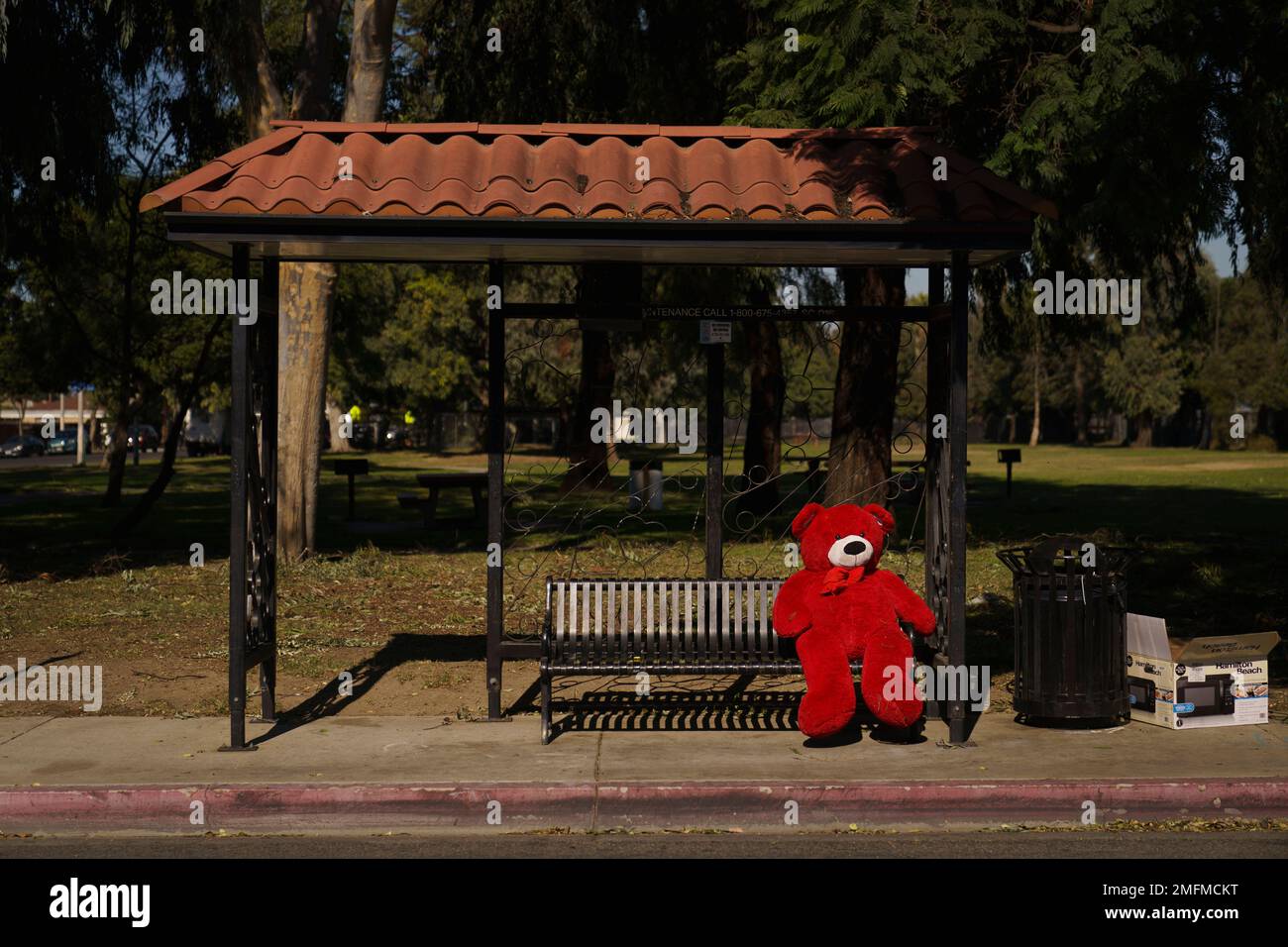 A stuffed bear is placed at a bus stop in Los Angeles, Tuesday, Nov. 10 ...