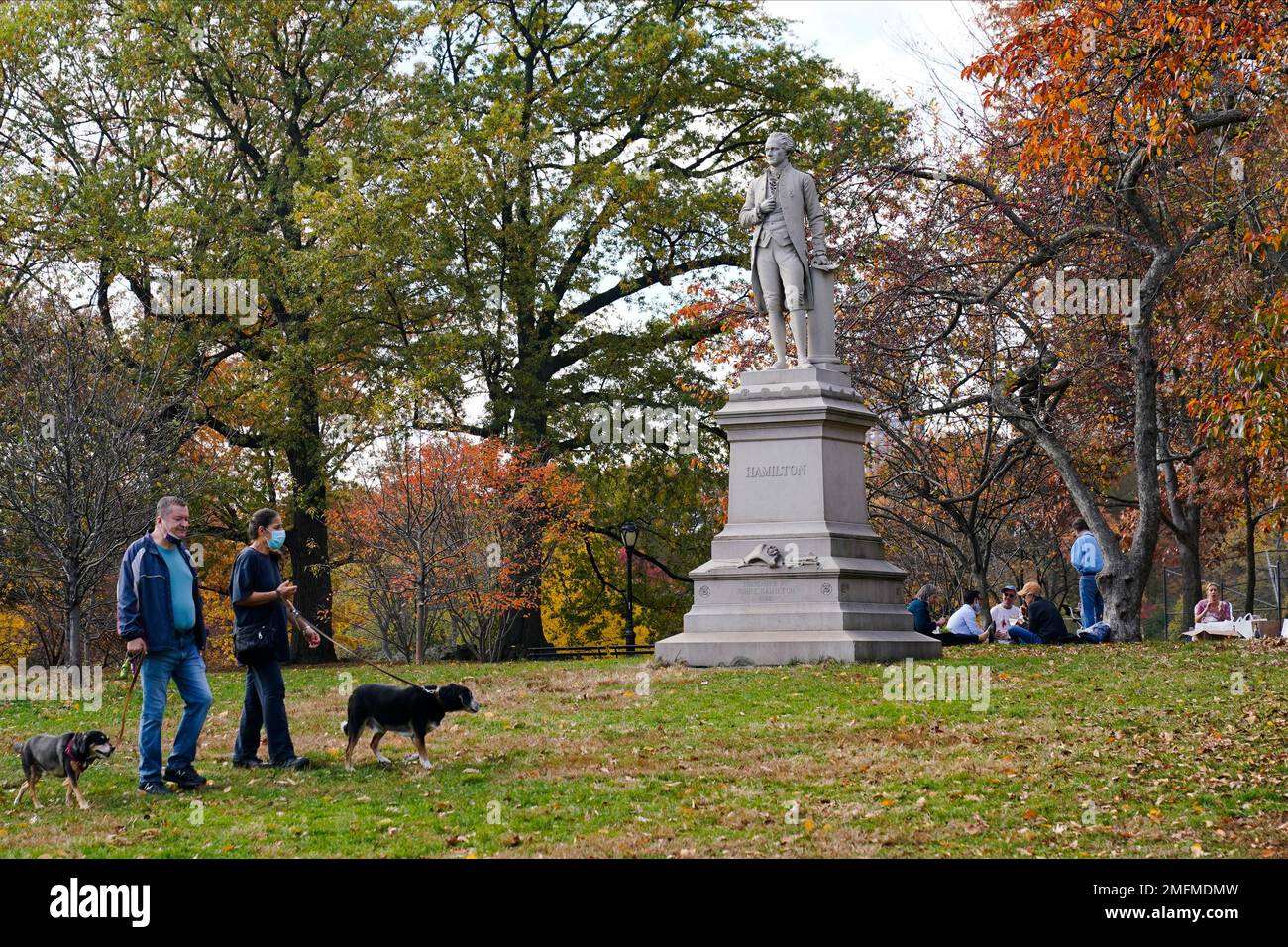 Pedestrians pass a statue of Alexander Hamilton in Central Park Tuesday ...