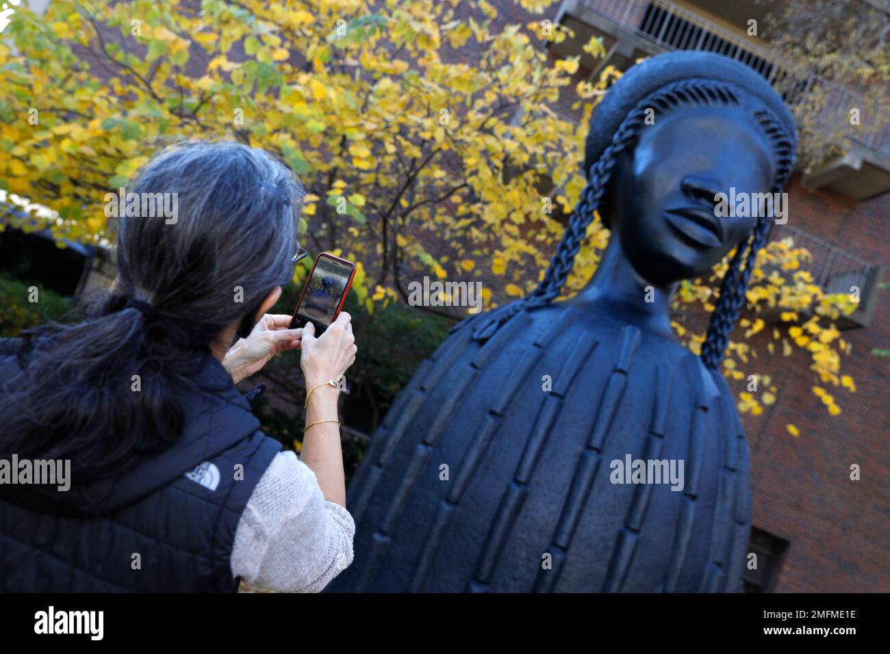 A University of Pennsylvania employee takes a picture of a newly ...