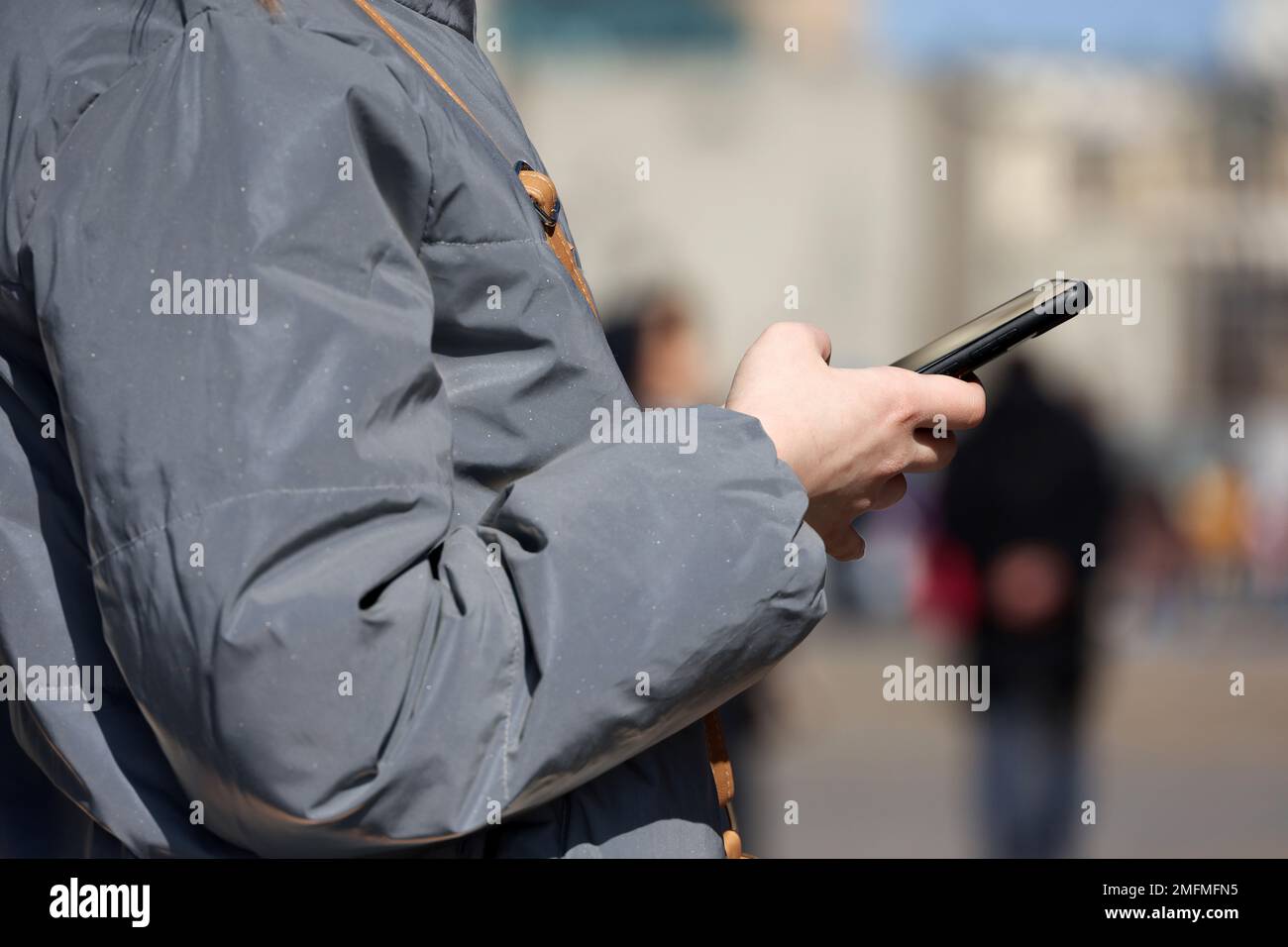 Female hands with smartphone close up on blurred people background ...