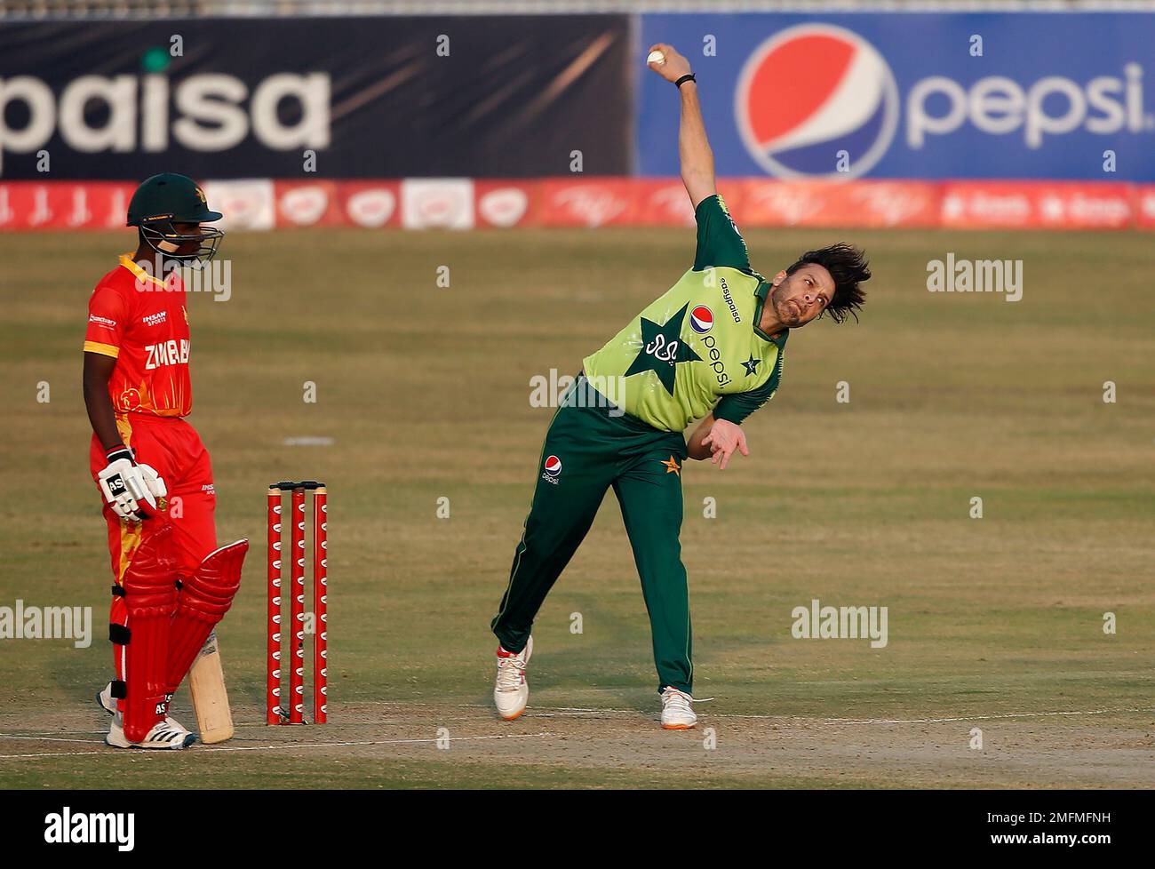 Pakistani spinner Usman Qadir, right, delivers a ball while Zimbabwe's ...