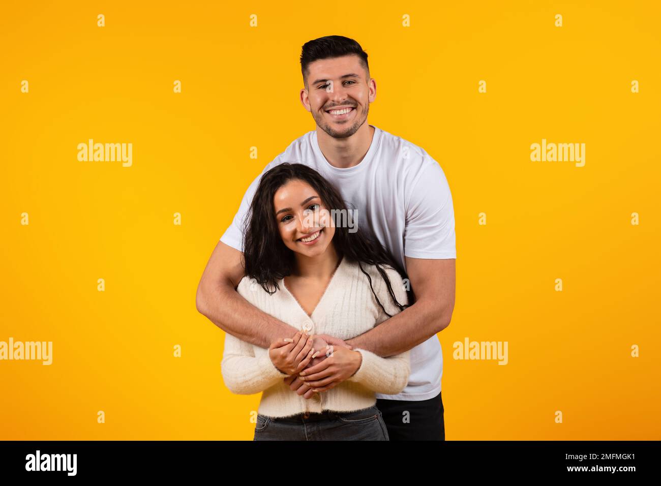 Happy family relationships. Cheerful young arab guy hugging female ...