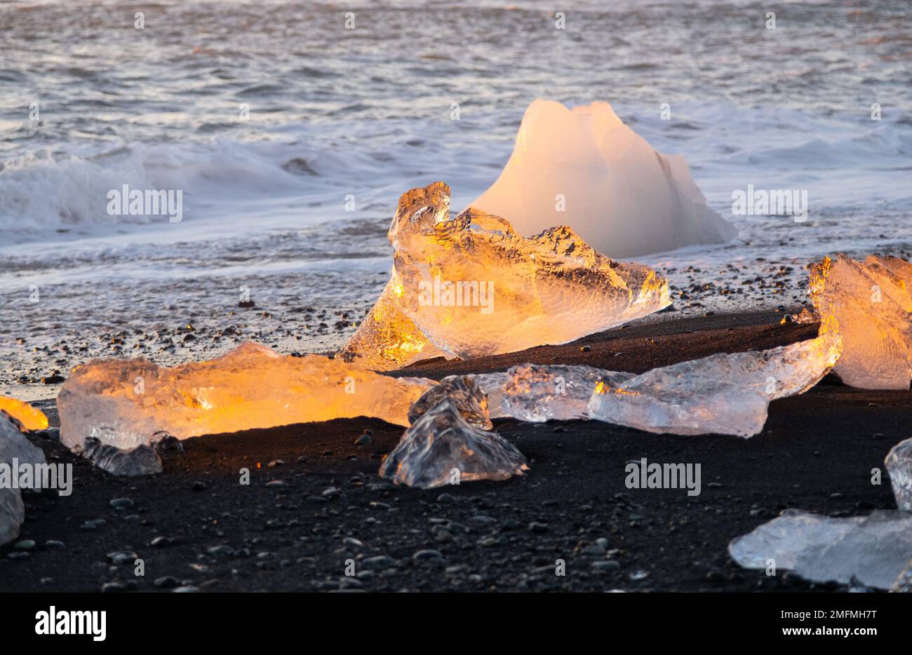 Diamond Beach. Iceberg Shining on Black Volcanic Sand at Sunset. Clear ...