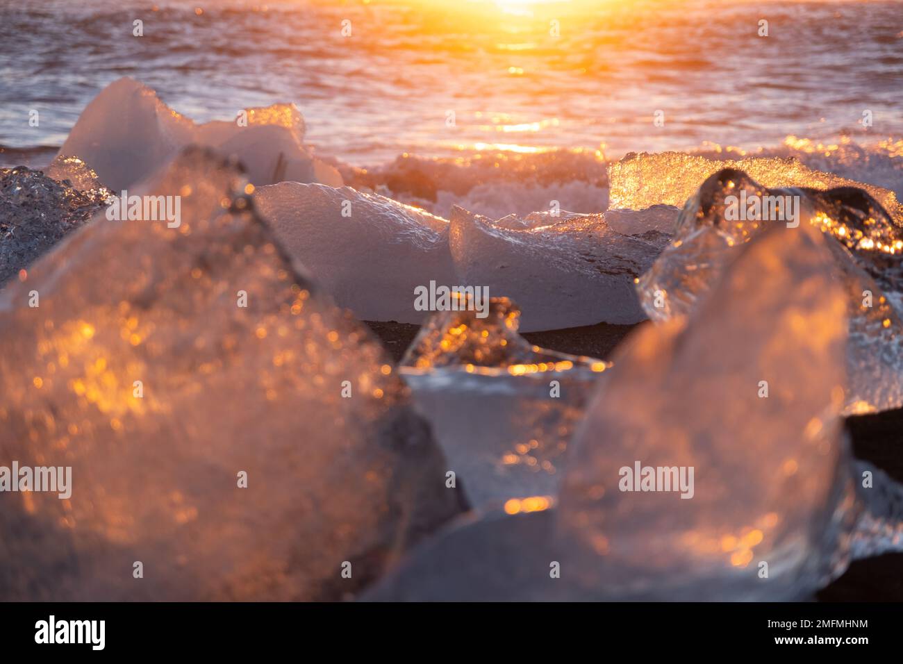 Diamond Beach. Iceberg Shining on Black Volcanic Sand at Sunset. Clear ...