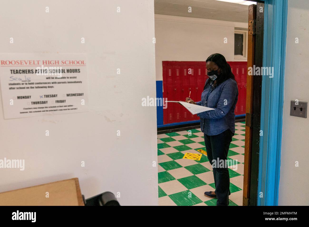 Lisa Seale goes over notes at the door to her chemistry classroom ...