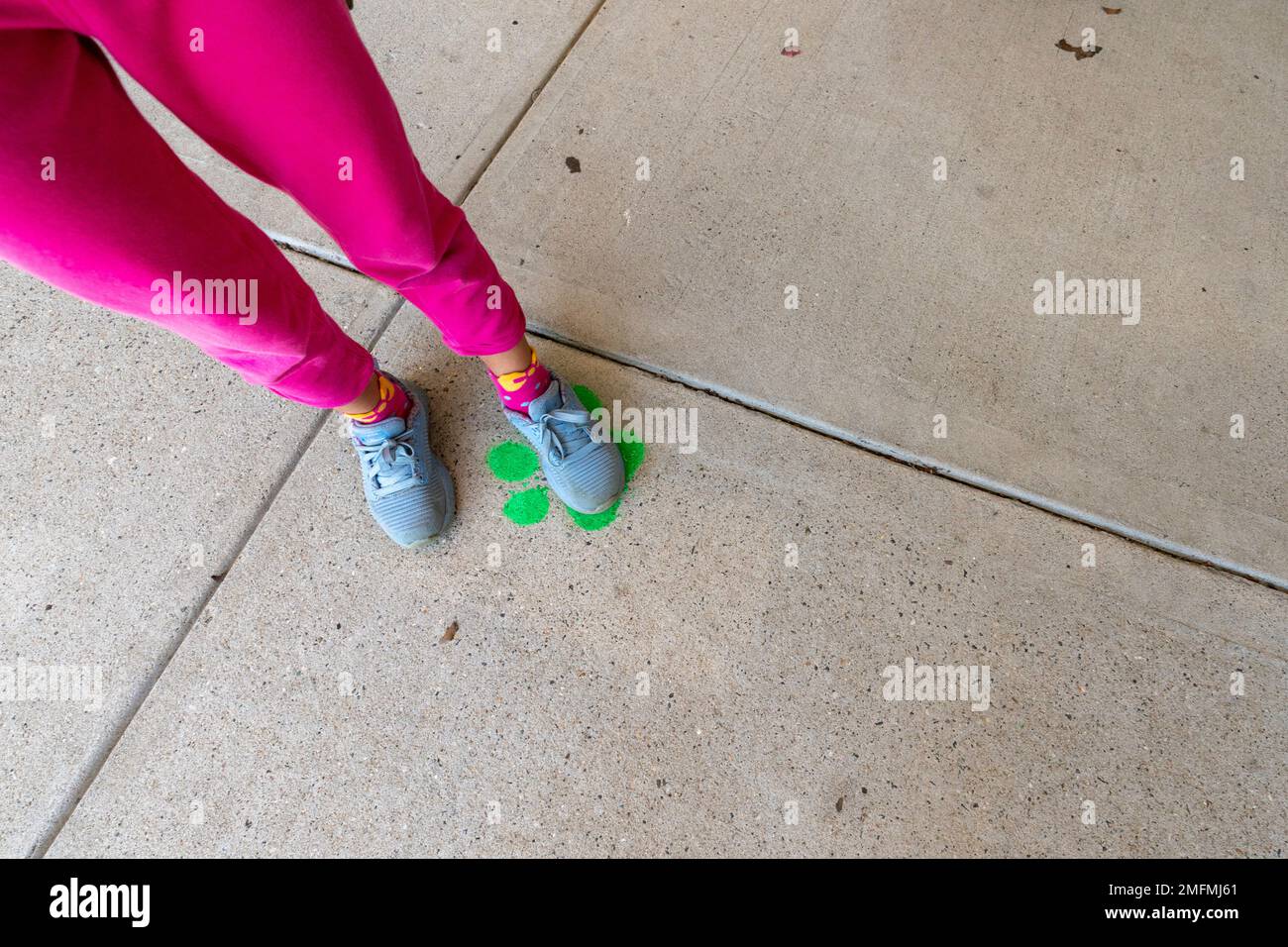 A Kindergarten student stands on a marker to insure proper social ...