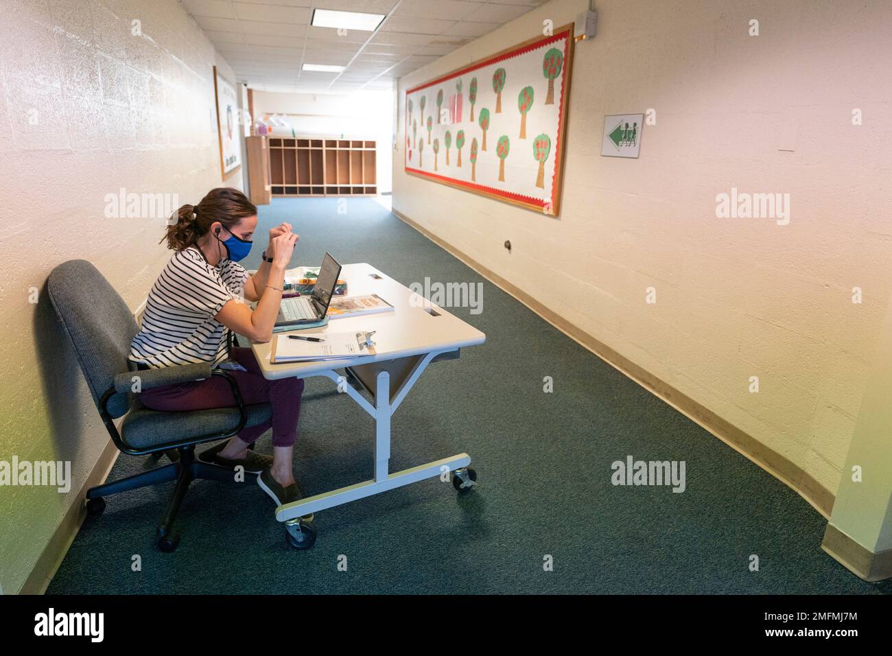 Katy Buderman teaches a first grade math class remotely in a hallway at ...