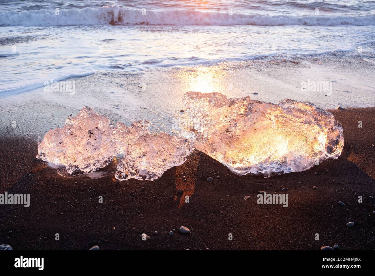 Diamond Beach. Iceberg Shining on Black Volcanic Sand at Sunset. Clear ...