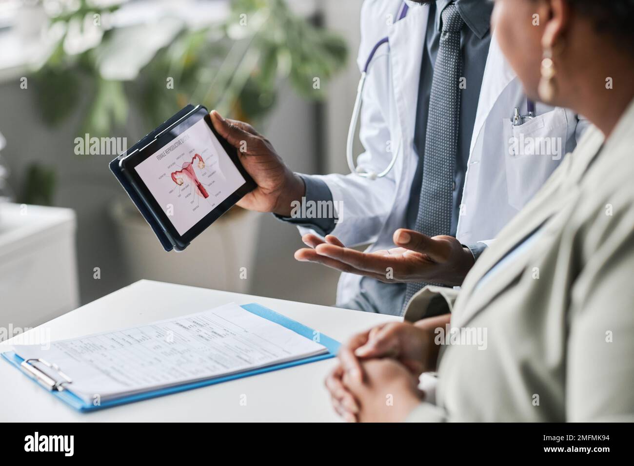 Close up of doctor holding tablet with female reproductive health ...