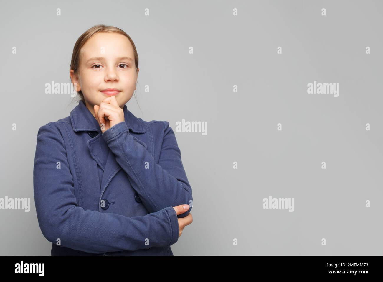 Beautiful little kid girl thinking on grey background with copy space ...