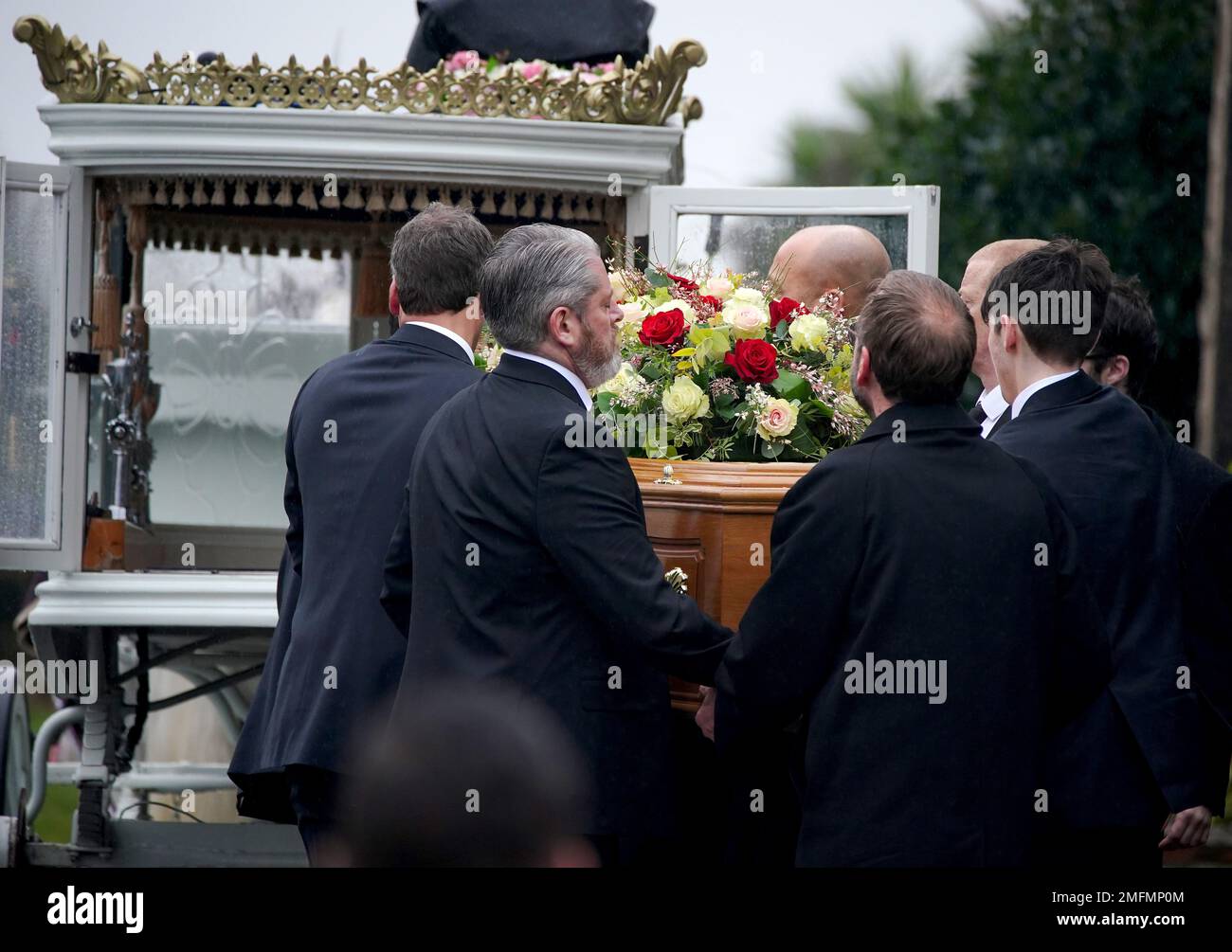 The bearer party, including father Tim Edwards (second left) lift the ...