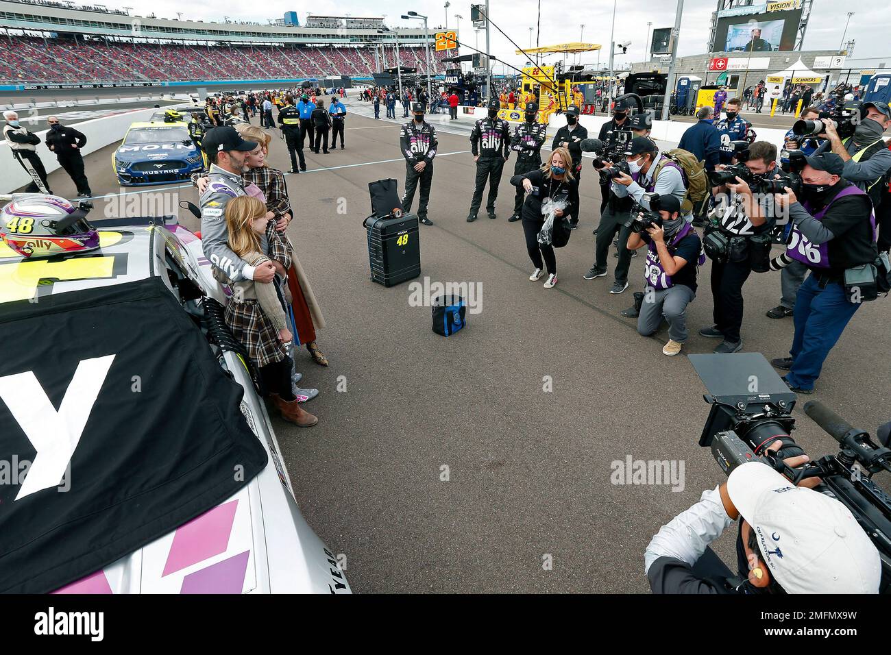 Jimmie Johnson, left, poses for photographers with his family on pit ...
