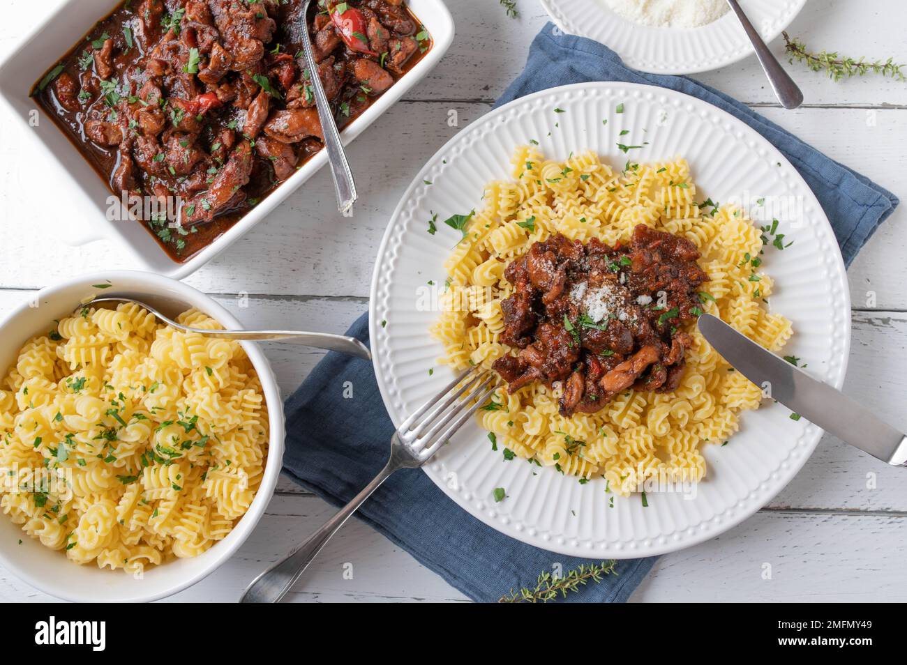 Italian chicken ragout with buttered pasta and parmesan cheese on white ...