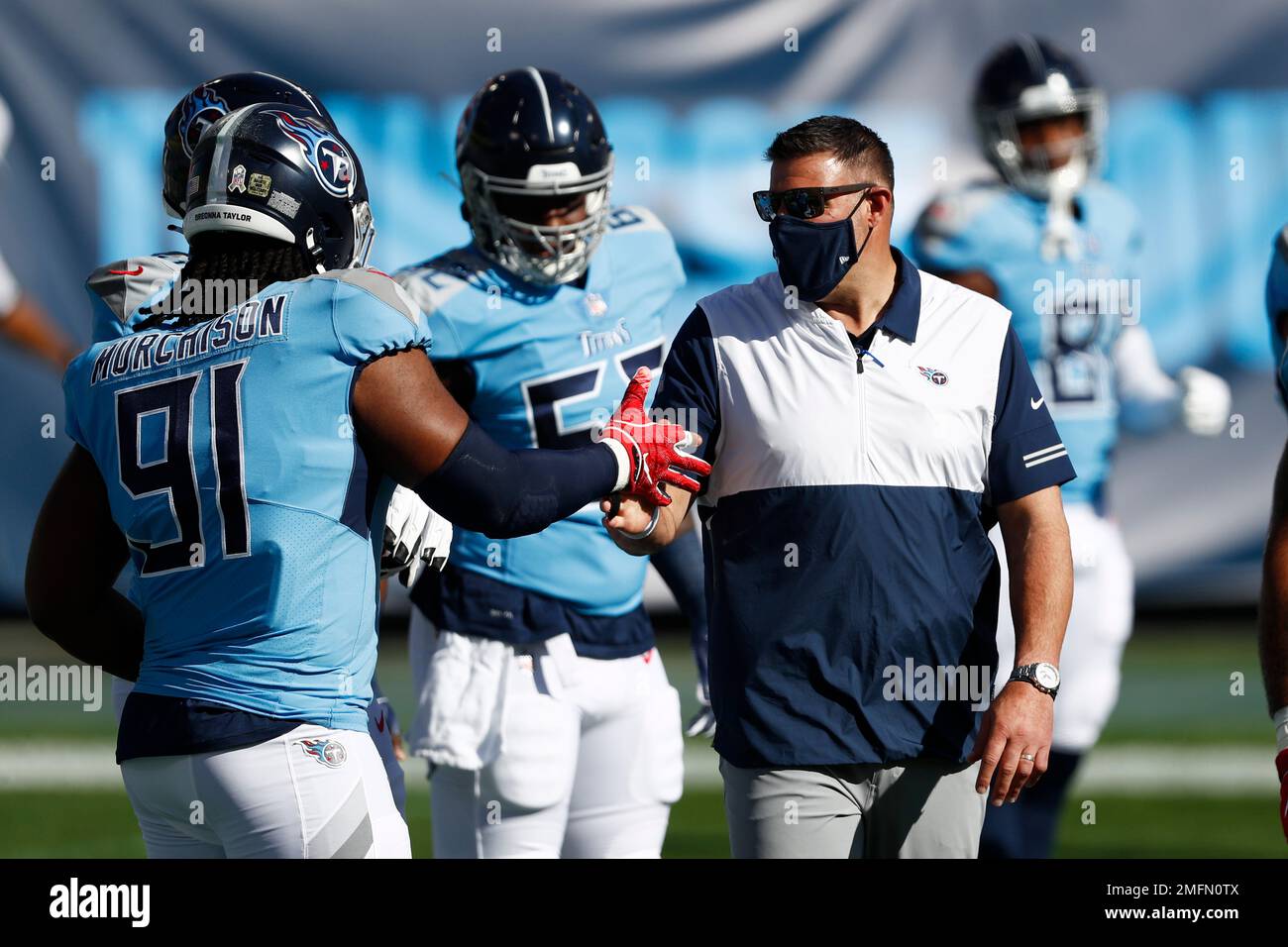 Tennessee Titans head coach Mike Vrabel shakes hands with defensive ...