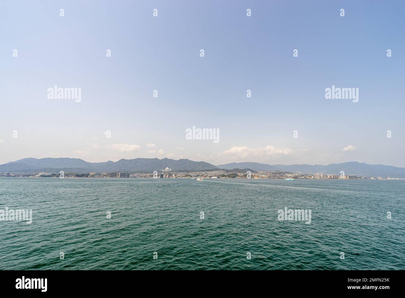 Beautiful landscape of Miyajima city with ferry boat from the island in ...