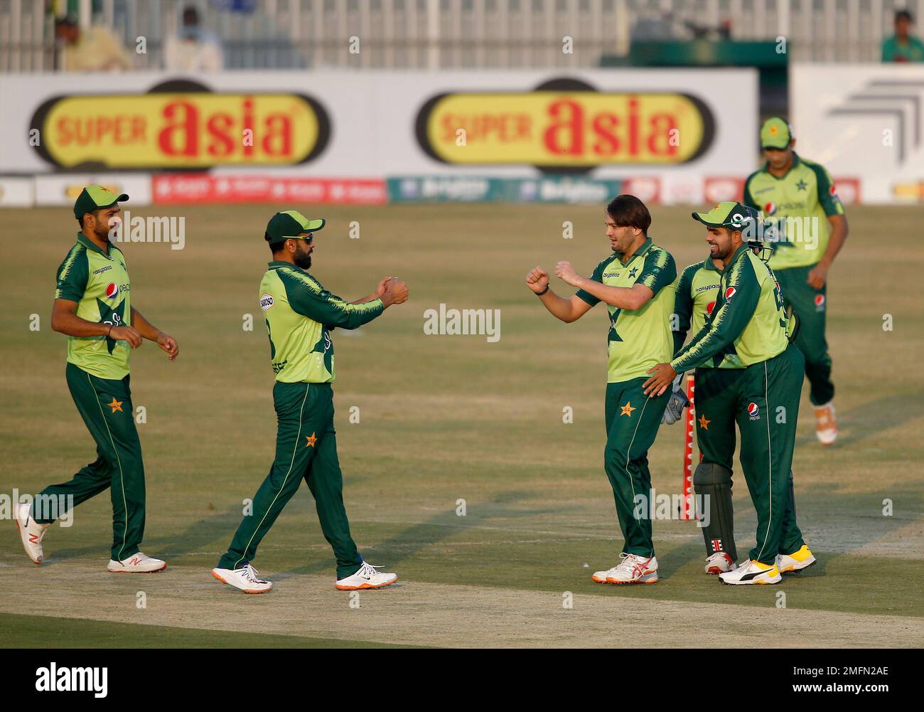 Pakistani spinner Usman Qadir, center, celebrates with teammates after ...