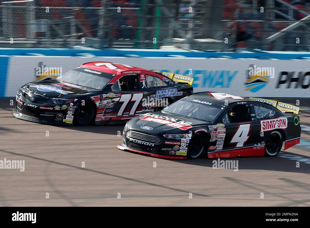 David Gilliland (4) and Takuma Koga (77), of Japan, race through Turn 4 ...