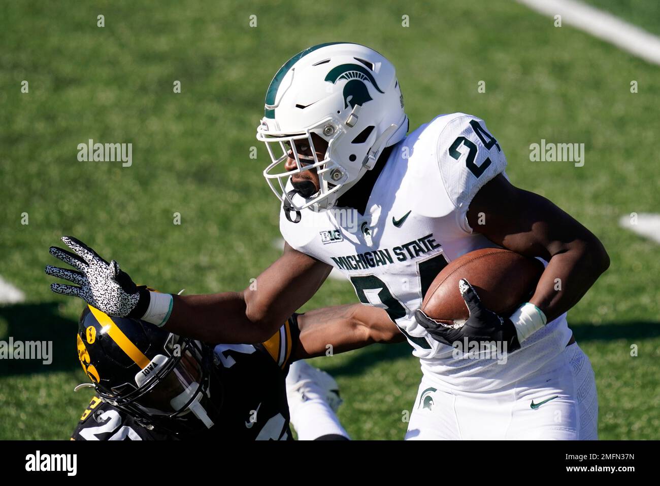Michigan State running back Elijah Collins (24) tries to break a tackle ...