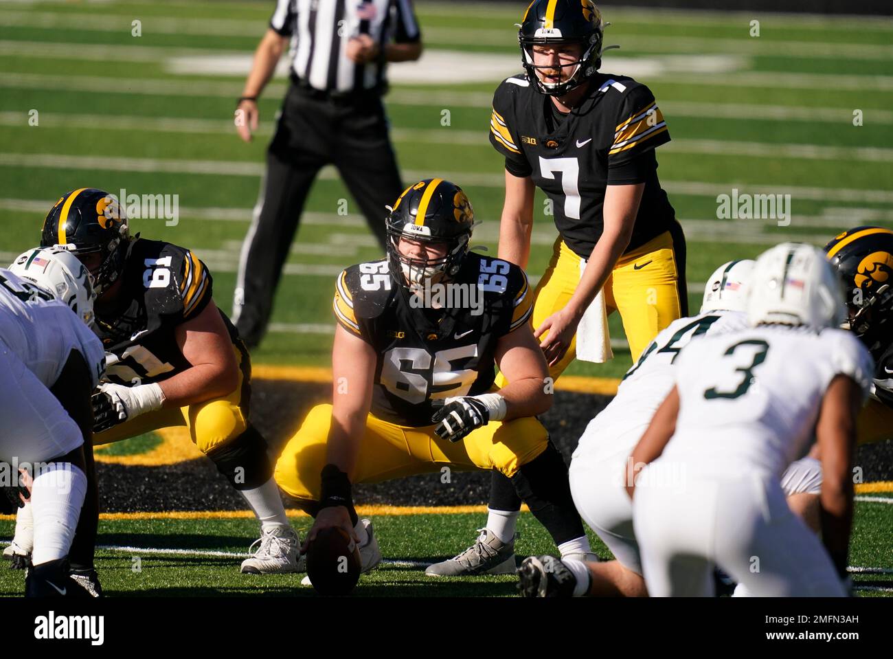 Iowa offensive lineman Tyler Linderbaum (65) gets set to snap the ball ...
