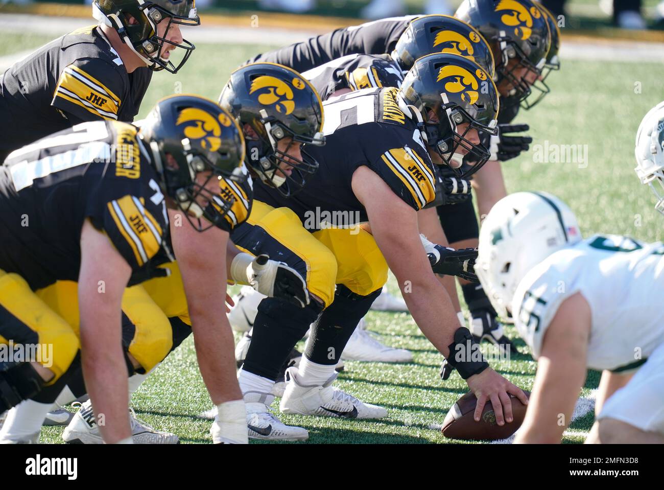 Iowa offensive lineman Tyler Linderbaum, center, gets set to snap the ...