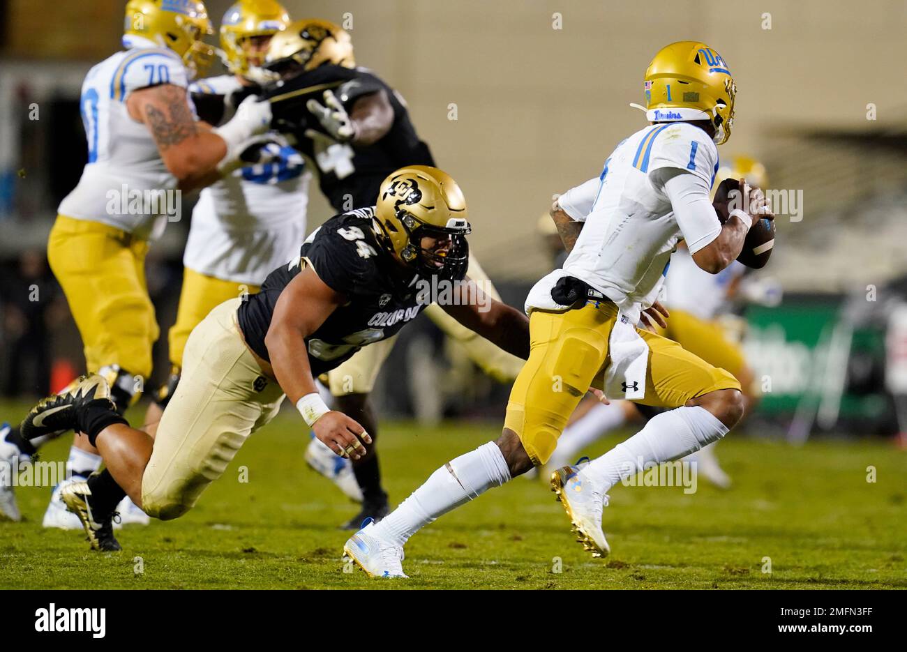 UCLA quarterback Dorian Thompson-Robinson, right, evades Colorado ...