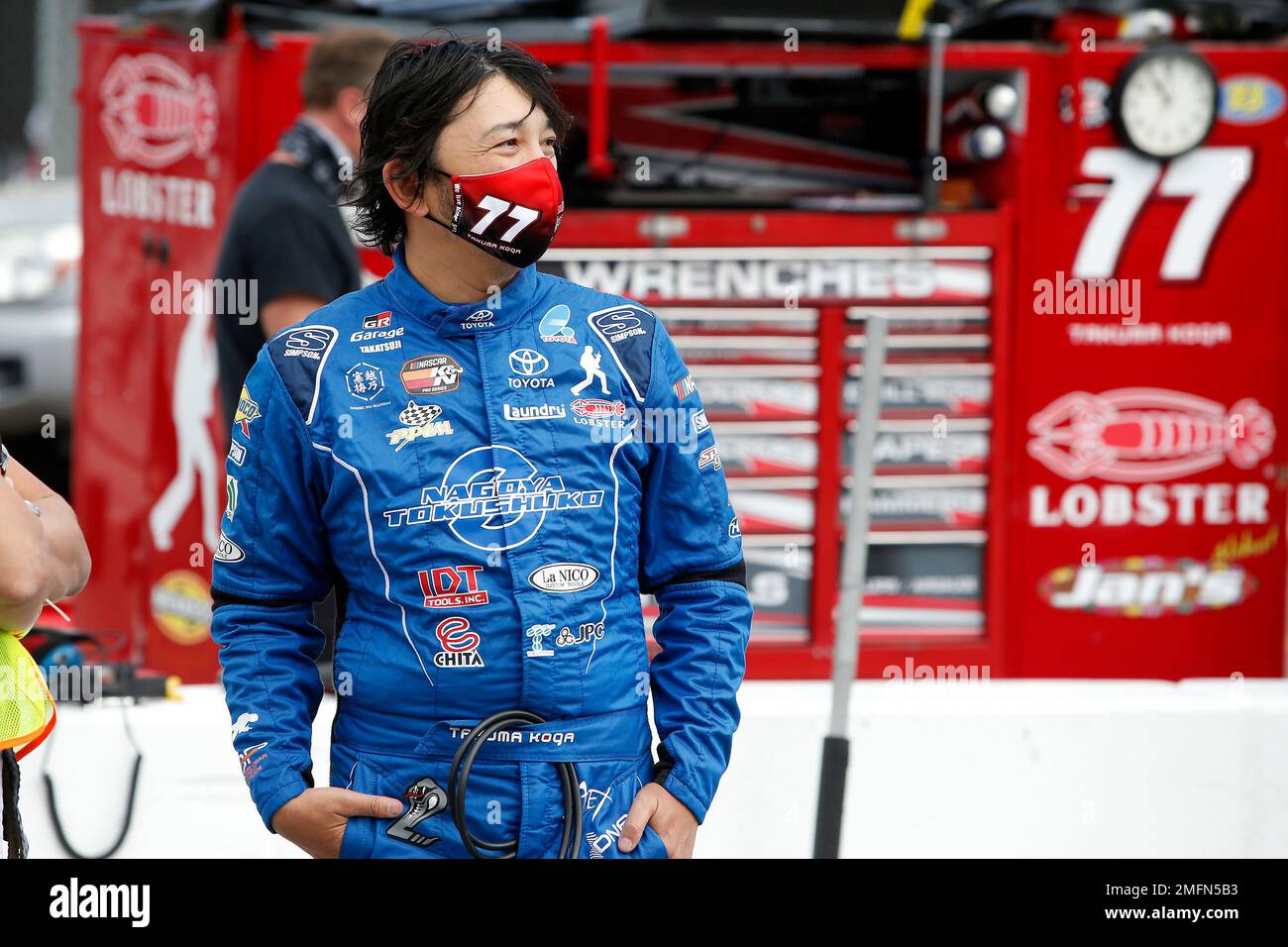 Takuma Koga, of Japan, looks on from pit road prior to an ARCA Series ...