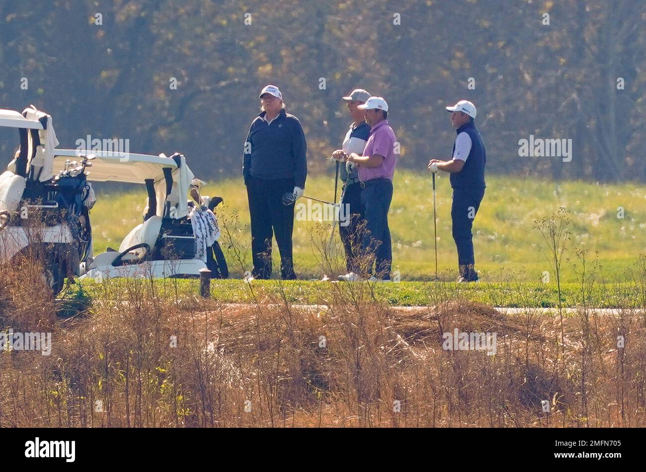 President Donald Trump, center standing, as he participates in a round ...